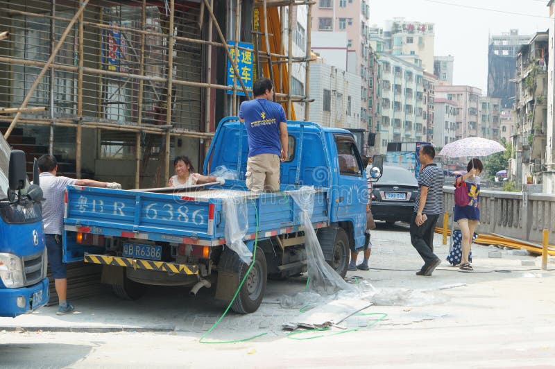 Construction Site, Workers are Loading and Unloading Building Materials ...