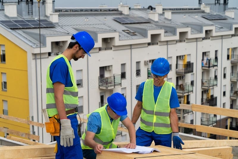 Construction Site Workers Stand Next To the Foreman and Looking at the ...