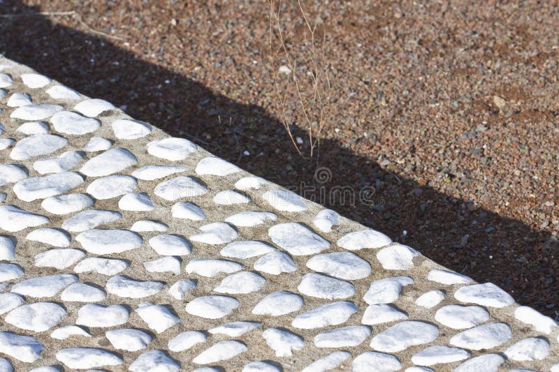 Construction of a Stone Pebble Pavement with a White Rounded Stone ...