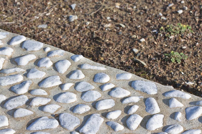 Construction of a Stone Pebble Pavement with a White Rounded Stone ...