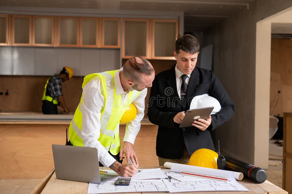 Construction and Structural Concept Engineers Working on Drawings at ...