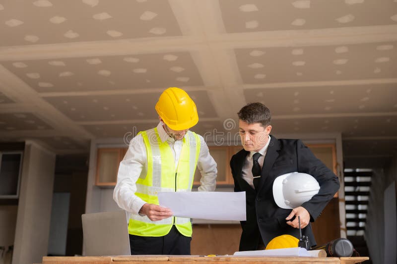 Construction and Structural Concept Engineers Working on Drawings at ...