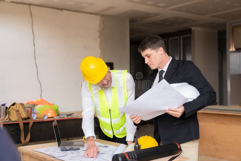 Construction and Structural Concept Engineers Working on Drawings at ...