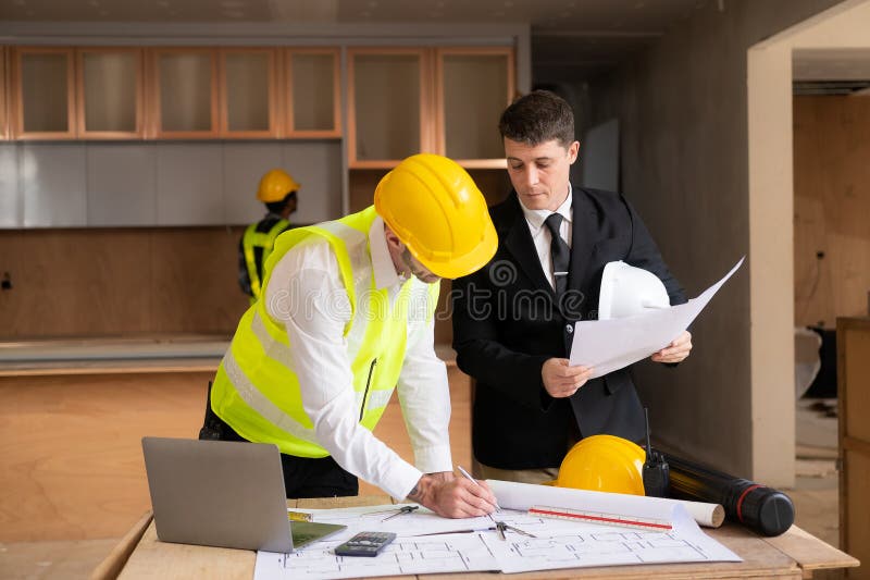 Construction and Structural Concept Engineers Working on Drawings at ...