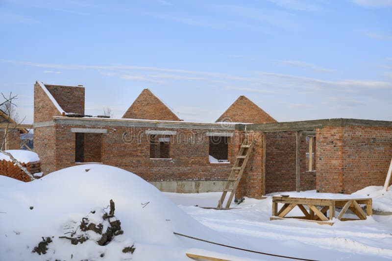 Construction of a Suburban Brick House on a Snowy Plot in Winter Stock ...