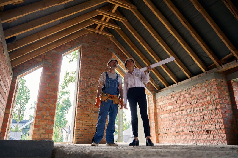 Construction Superintendent and Builder Conducting Inspection of House ...