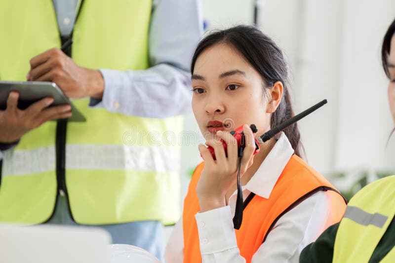 Construction Supervisor Communicating with Team Using a Walkie-talkie ...