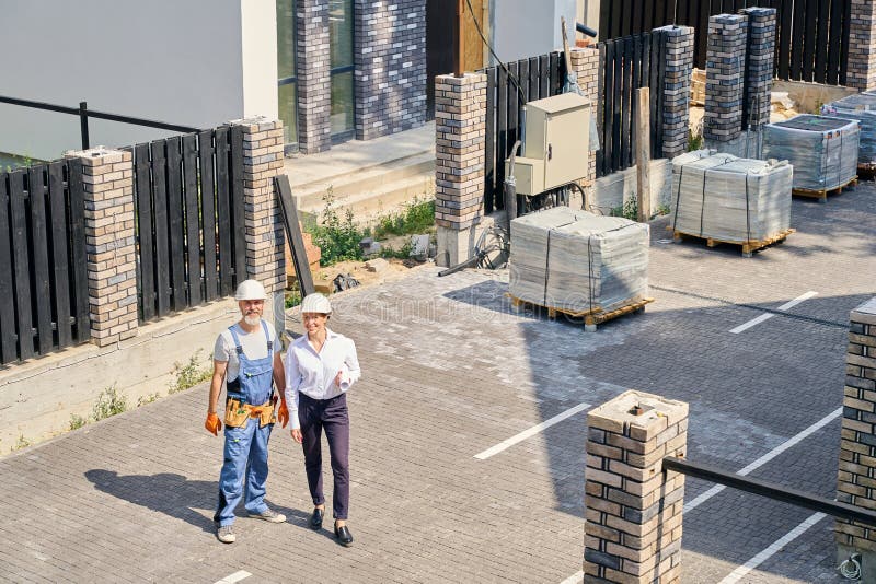 Construction Supervisor and Contractor Conducting Inspection of ...