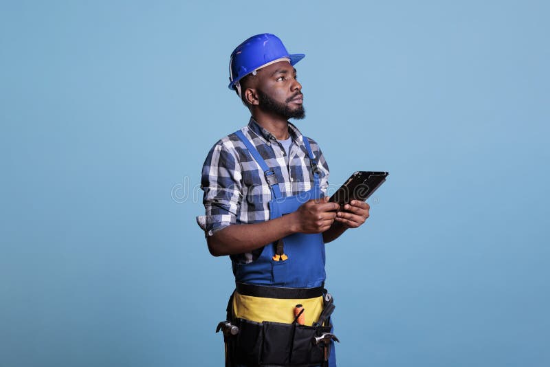 Construction Supervisor Holds Device in Studio Shot Stock Photo - Image ...