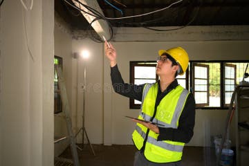 Construction Supervisor Inspecting Electrical Wiring at Construction Site Stock Image - Image of ...