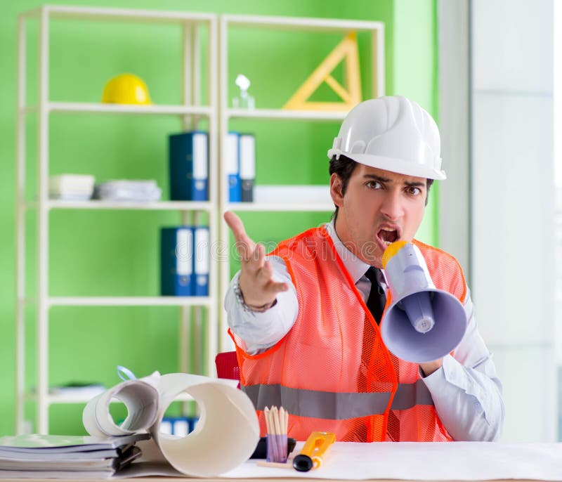 Construction Supervisor with Loudspeaker Sitting in the Office Stock ...