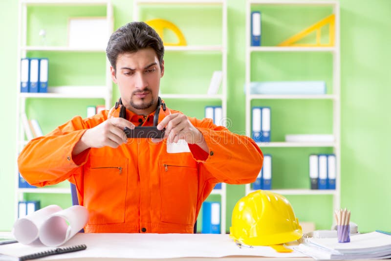 The Construction Supervisor Planning New Project in Office Stock Photo ...