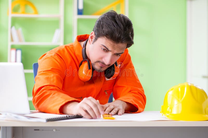 The Construction Supervisor Planning New Project in Office Stock Photo ...