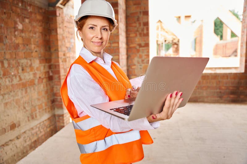 Construction Supervisor Using Laptop during Inspection of Residential ...