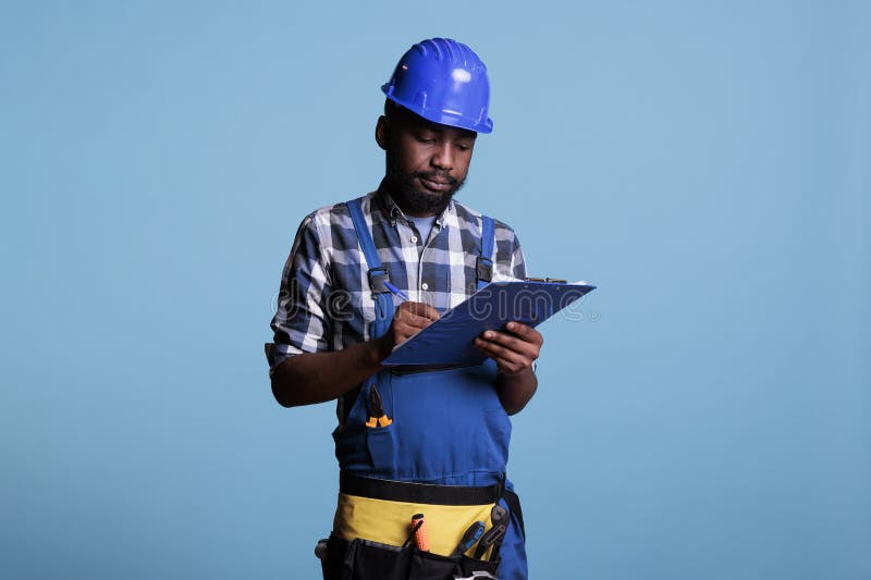 Construction Supervisor Writing on Clipboard Stock Photo - Image of ...