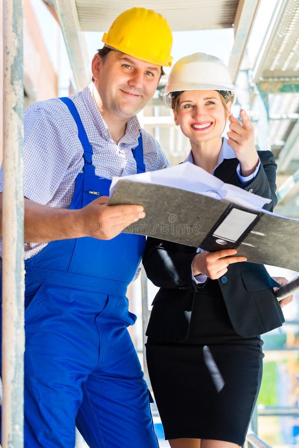 Construction Site Workers Checking Building Shell Stock Image - Image ...