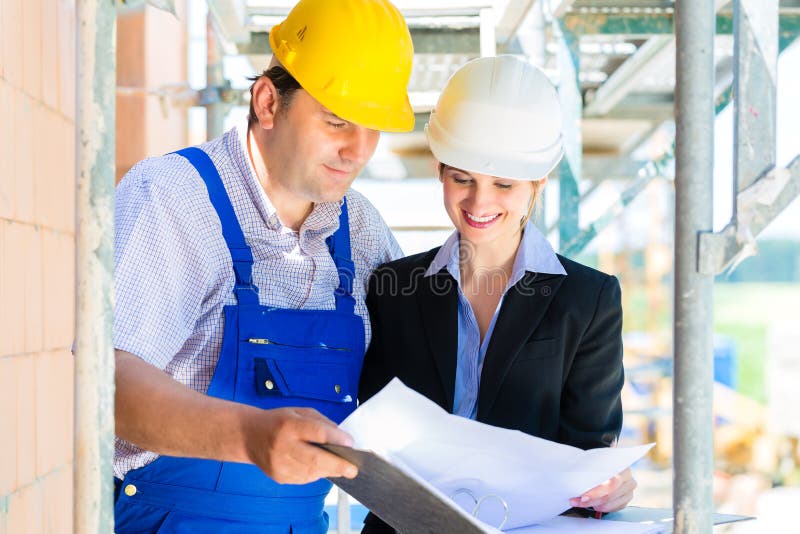 Construction Team with Building Plans on Site Stock Image - Image of ...