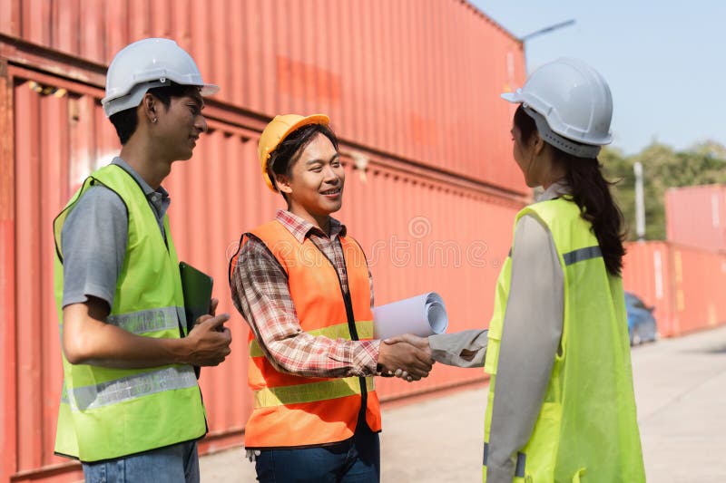 Construction Team Collaborating and Shaking Hands Over Project Plans ...