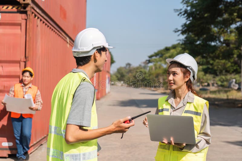 Construction Team Engaged in Discussion and Planning Near Shipping ...