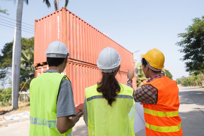 Construction Team Evaluating the Project Site and Discussing Plans with ...