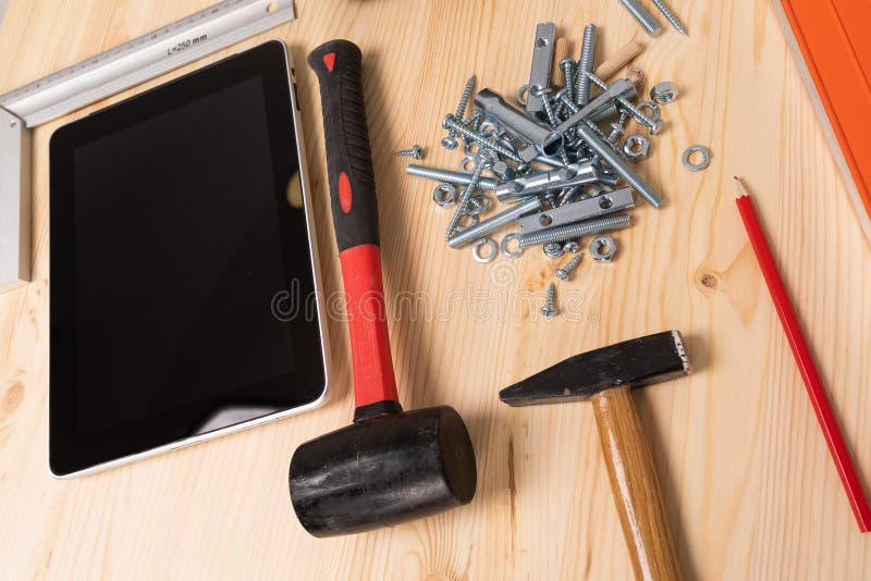 Construction Tool and a Digital Tablet Lie on a Light Wooden Table ...