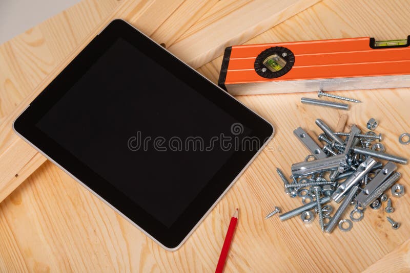Construction Tool and a Digital Tablet Lie on a Light Wooden Table ...