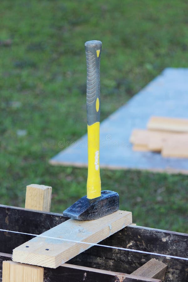 Construction Tool Hammer with a Yellow Handle Lies on the Formwork ...