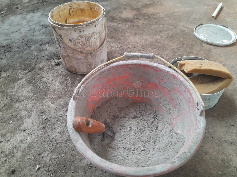 Construction Tools Including a Bucket of Cement, Sponge, and Masonry ...
