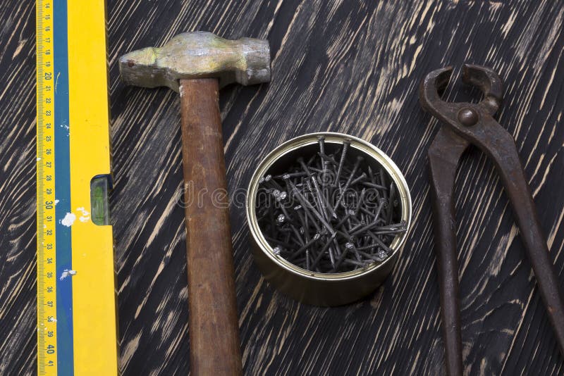 Construction Tools: Level, Hammer, Pliers and Nails. Stock Photo ...