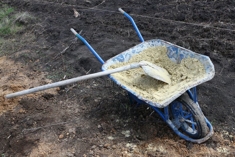 Construction Tools - a Shovel and the Cart on Wheels with Sand Stock ...