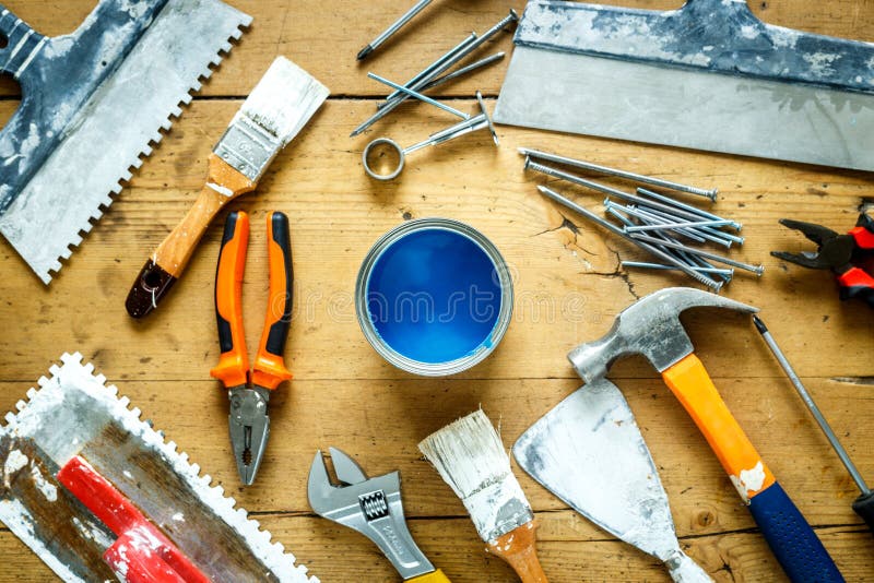 Construction Tools on a Wooden Table with Blue Paint Stock Photo ...
