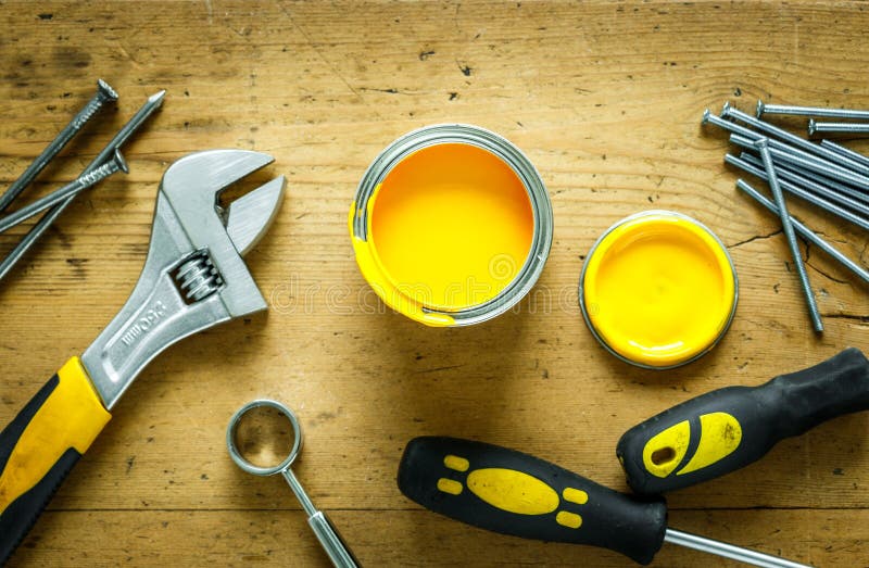 Construction Tools on a Wooden Table with Yellow Paint Stock Photo ...