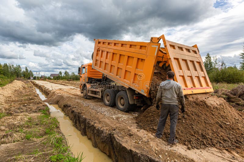 Construction Truck Tipping or Dumping Sand on Road during Construction ...