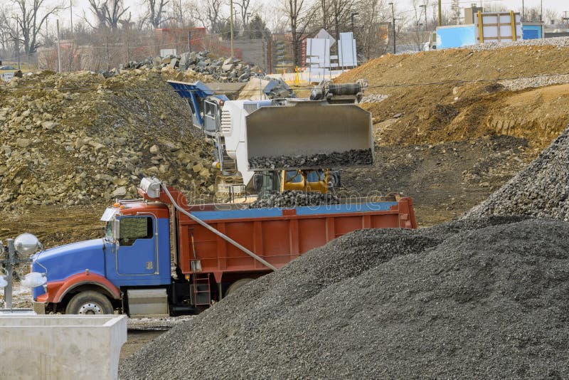 A Construction Vehicle Loading Gravel into a Huge Dump Truck Stock ...