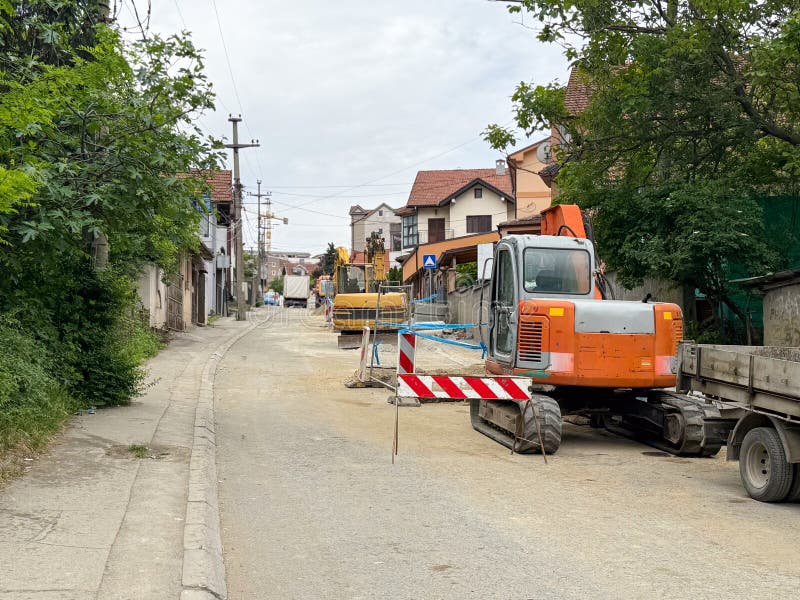 Construction Vehicles and Barriers on Quiet Residential Street Under ...