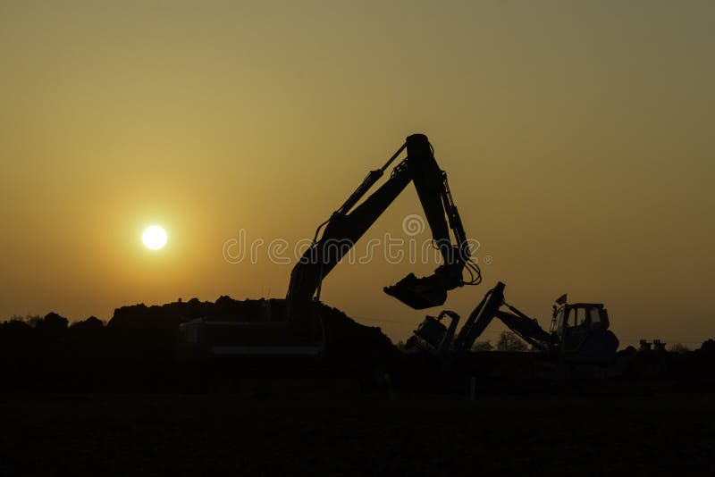 Construction Vehicles in the Sunset Stock Photo - Image of clean ...