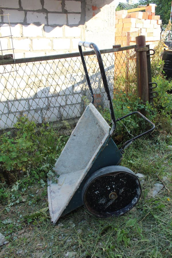 Construction Wheelbarrow on the Grass. Use of Construction Equipment at ...