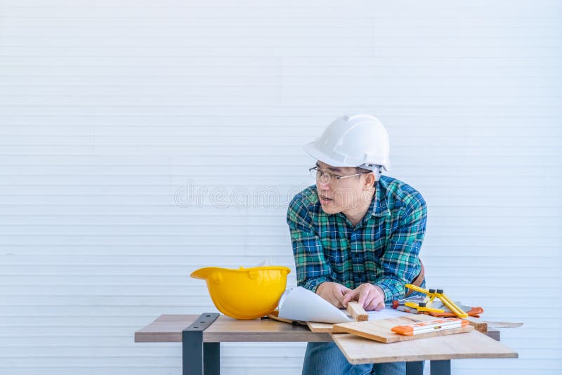 Construction Builder with Tools and Paper Plan on Working Table Stock ...