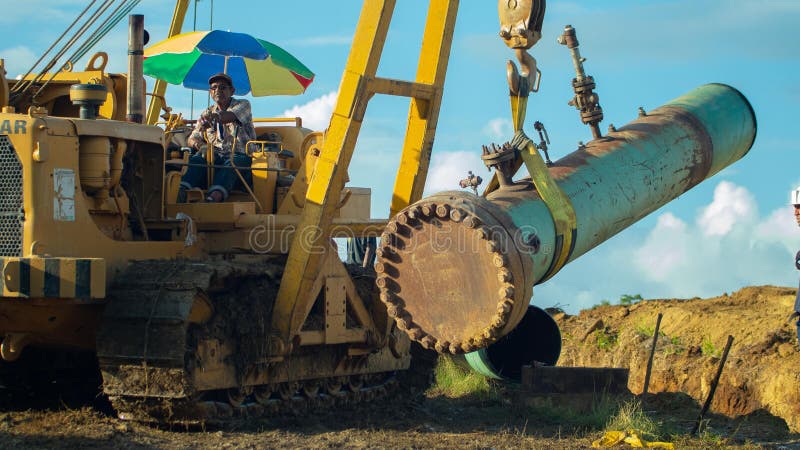 Construction Work- the Crane Lifting the Beam in the Field and the ...