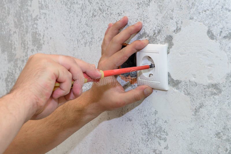 Construction Work, the Electrician Installs the Socket Stock Photo ...
