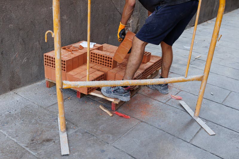 Construction Work - Mason Lifting a Heavy Red Brick with Gloves Stock ...