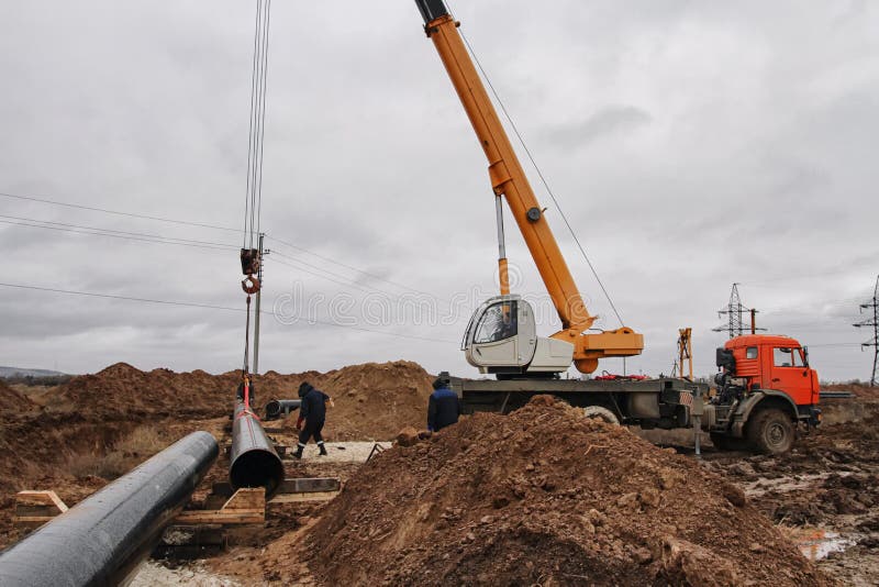 Construction Work on the Pipe Laying of the Pipeline into Trench Using ...
