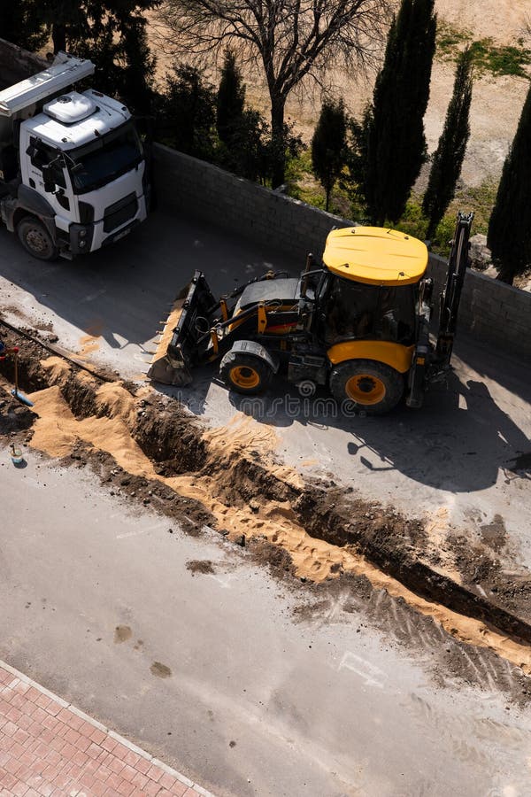 Construction Work in Progress with Excavator on a Road during Daytime ...