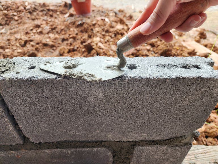 Construction Work by Putting Bricks Together and Plastering the Walls ...