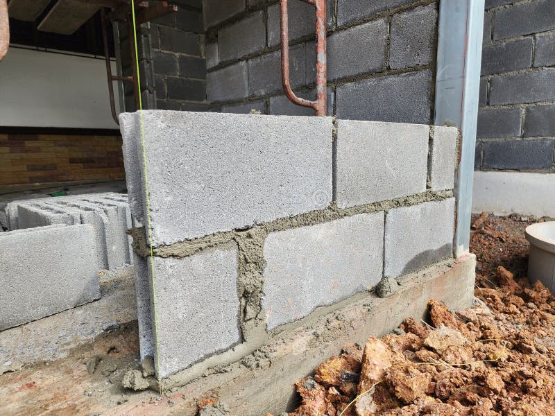 Construction Work by Putting Bricks Together and Plastering the Walls ...