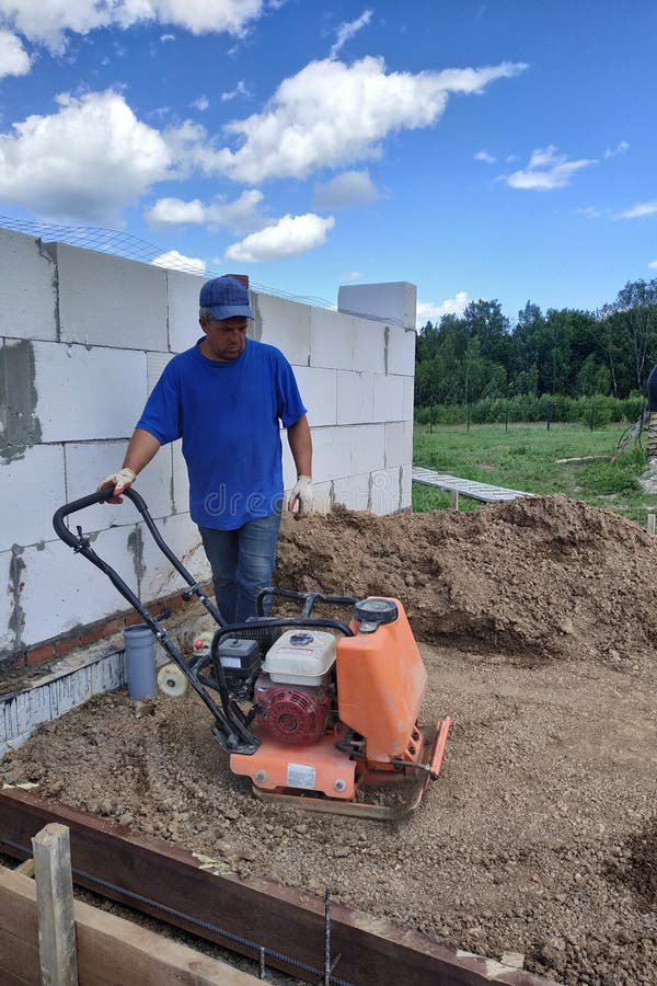 Construction Work on the Construction Site, Soil Compaction with a ...