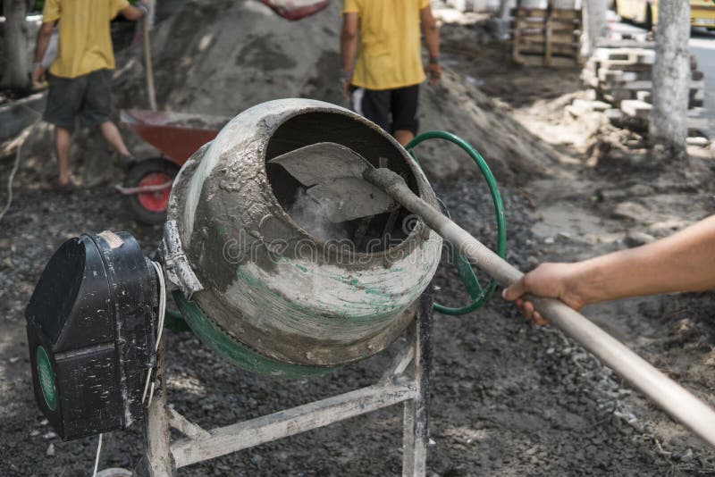 Construction Worker Add Ingredients for Mixing in the Concrete Mixer at ...
