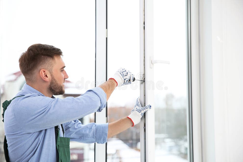 Construction Worker Adjusting Installed Window with Screwdriver Stock ...