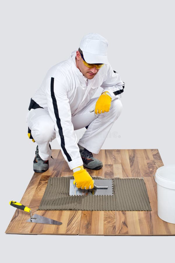 Construction Worker Applyes Tile Adhesive on Wooden Floor Stock Image ...