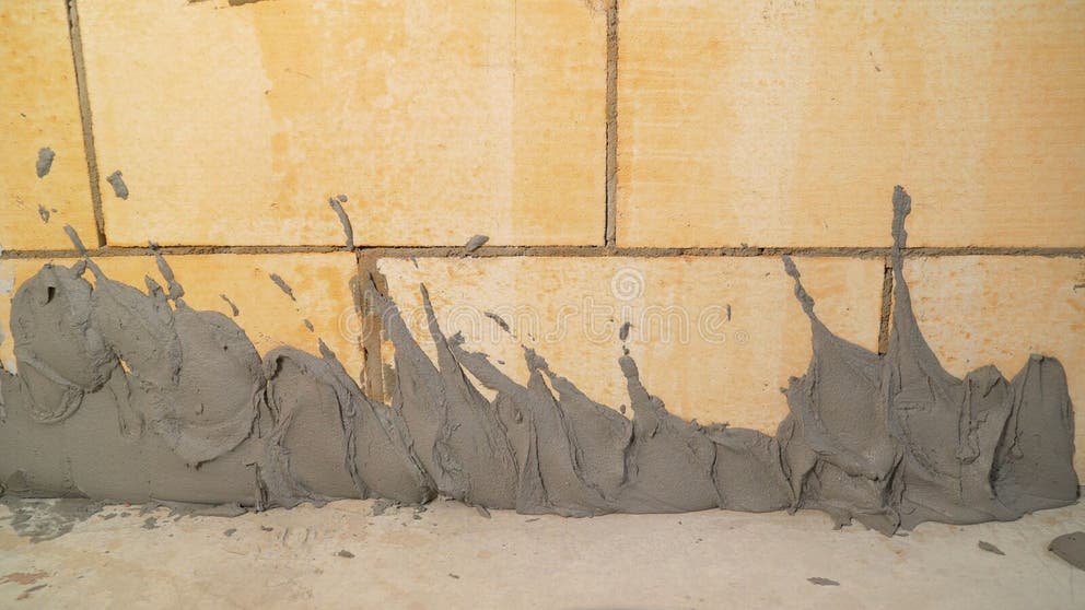Construction Worker Applying Cement on Bricks Using Trowel in a ...